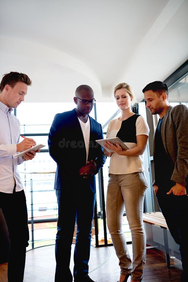 Group of Young Executives Gathered at Work. Stock Photo - Image of ...