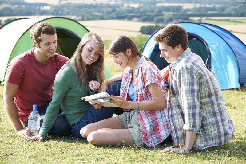 Group of Young Friends Camping in Countryside Reading Map Stock Image ...