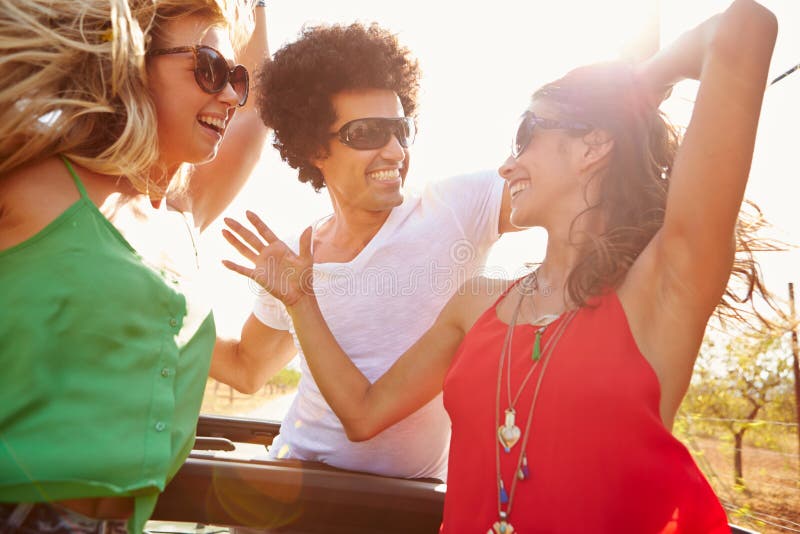 Group of Young Friends Dancing in Back of Open Top Car Stock Photo ...