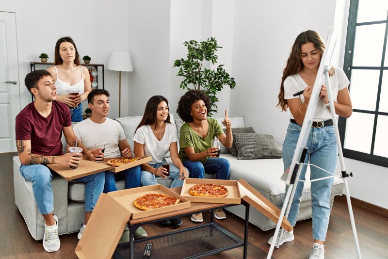 Group of Young Friends Eating Pizza and Playing Draw Game at Home Stock ...