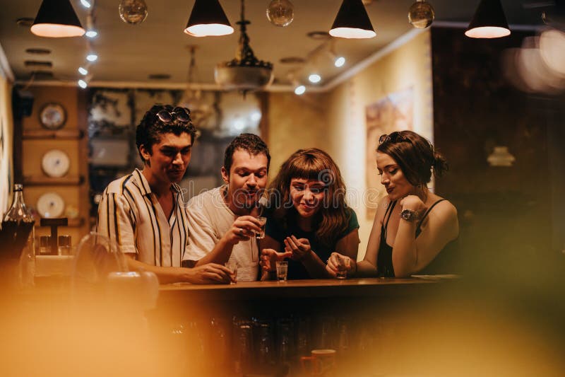 Young Friends Enjoying a Night Out at the Bar with Drinks Stock Photo ...