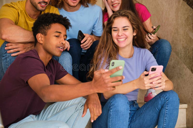 Group of Young Friends Having Fun Sharing Media with a Cellphone at ...