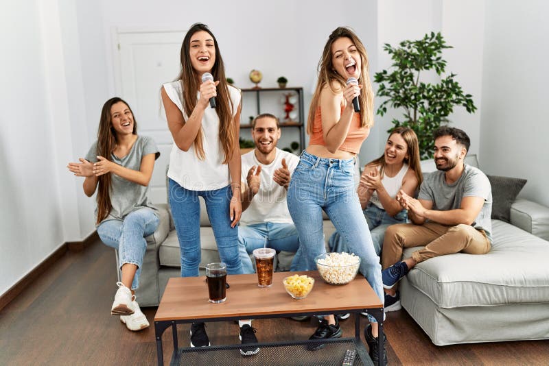 Group of Young Friends Having Party Singing Song Using Microphone at ...