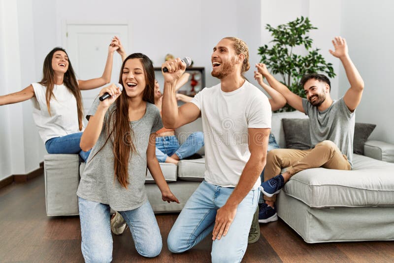 Group of Young Friends Having Party Singing Song Using Microphone at ...