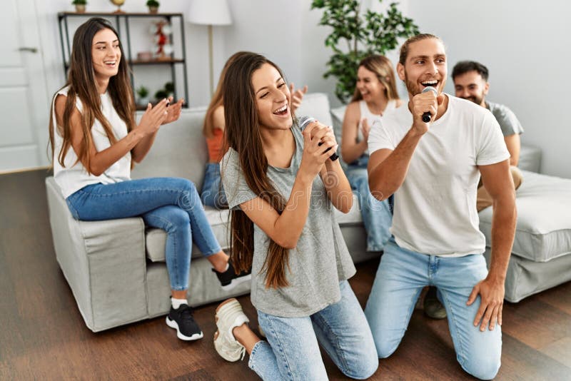 Group of Young Friends Having Party Singing Song Using Microphone at ...