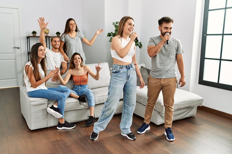 Group of Young Friends Having Party Singing Song Using Microphone at ...