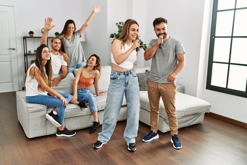 Group of Young Friends Having Party Singing Song Using Microphone at ...