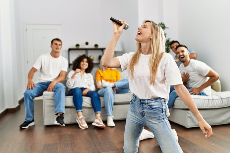 Group of Young Friends Having Party Singing Song Using Microphone at ...