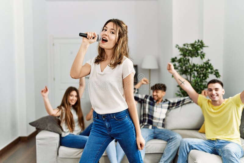 Group of Young Friends Having Party Singing Song Using Microphone at ...