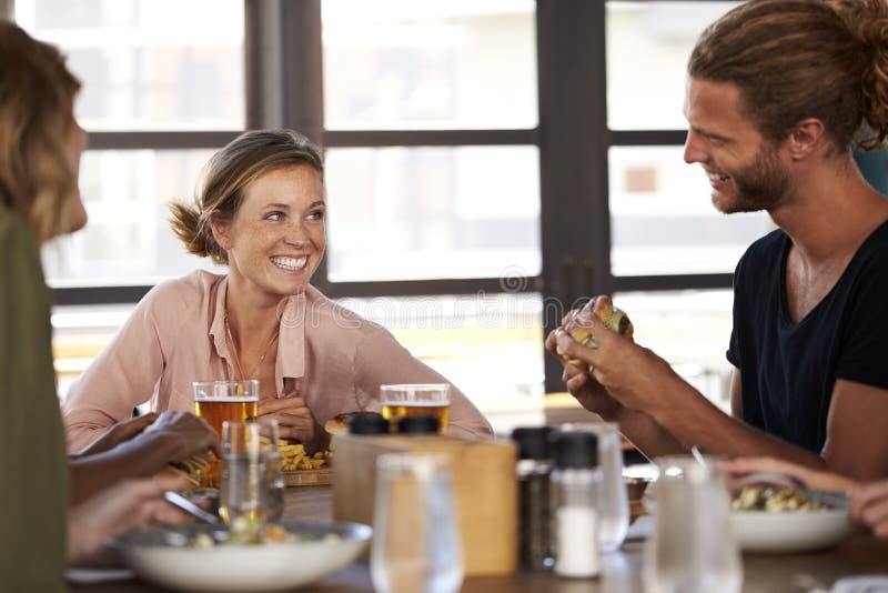 Group of Young Friends Meeting for Drinks and Food in Restaurant Stock ...
