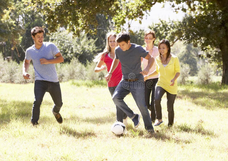 Group of Young Friends Playing Soccer in Countryside Stock Photo ...