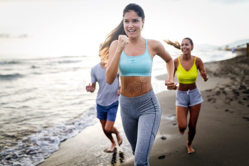 Group of Young Friends Running and Exercising on the Beach Stock Image ...