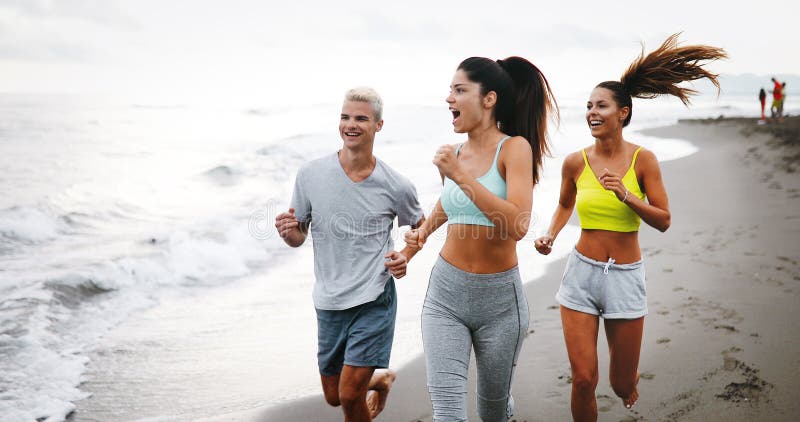 Group of Young Friends Running and Exercising on the Beach Stock Image ...
