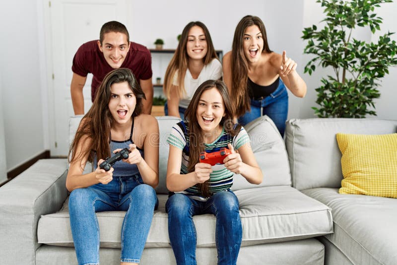 Group of Young Friends Smiling Happy Playing Video Game at Home Stock ...