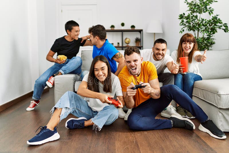 Group of Young Friends Smiling Happy Playing Video Game at Home Stock ...