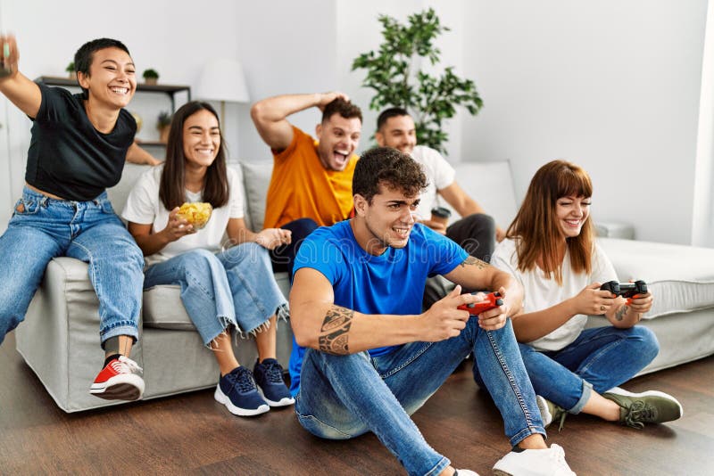 Group of Young Friends Smiling Happy Playing Video Game at Home Stock ...
