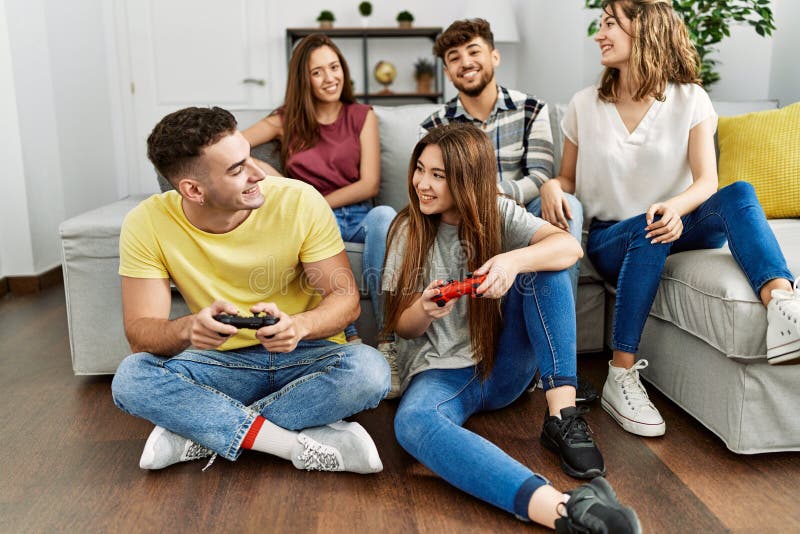 Group of Young Friends Smiling Happy Playing Video Game at Home Stock ...