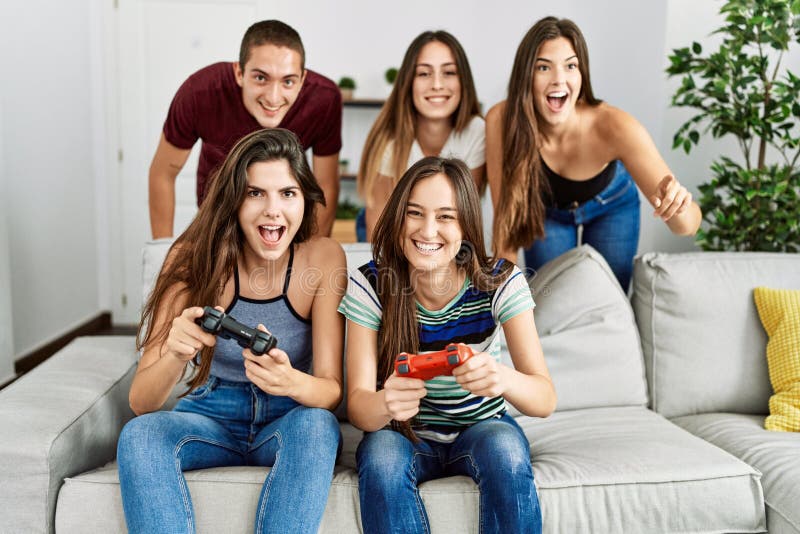 Group of Young Friends Smiling Happy Playing Video Game at Home Stock ...