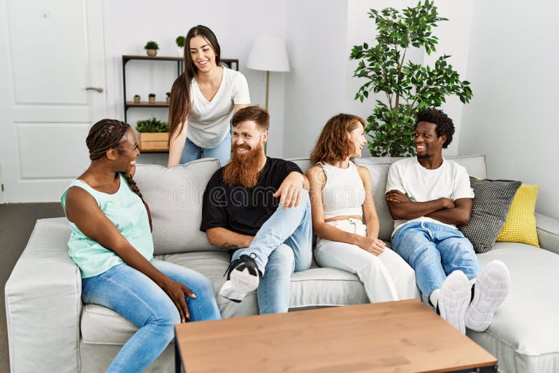 Group of Young Friends Smiling Happy Sitting on the Sofa at Home Stock ...