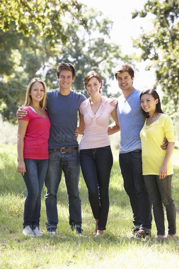 Group of Young Friends Walking through Countryside Stock Image - Image ...