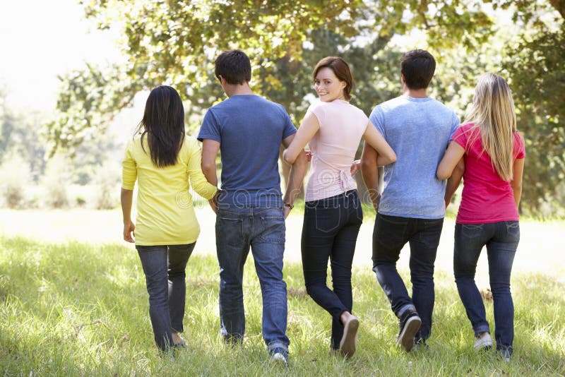 Group of Young Friends Walking through Countryside Stock Image - Image ...
