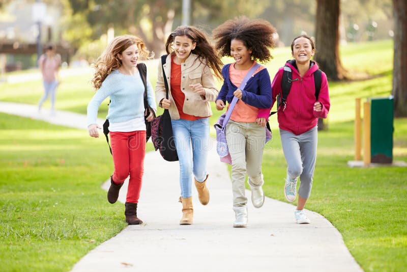 Group of Young Girls Running Towards Camera in Park Stock Image - Image ...