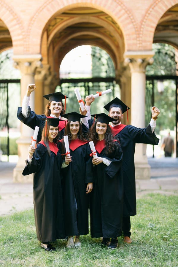Group of Young Graduate Students Holding Their Diploma after Graduation ...