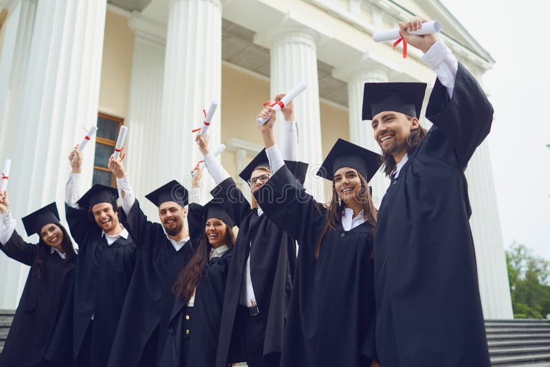 A Group of Graduate Students Raised Their Hands with Diplomas Up Stock ...