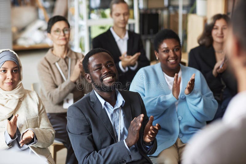 Group of Young Intercultural People Sitting in Row and Clapping Hands ... Group of Young Intercultural People Sitting in Row and Clapping Hands ...