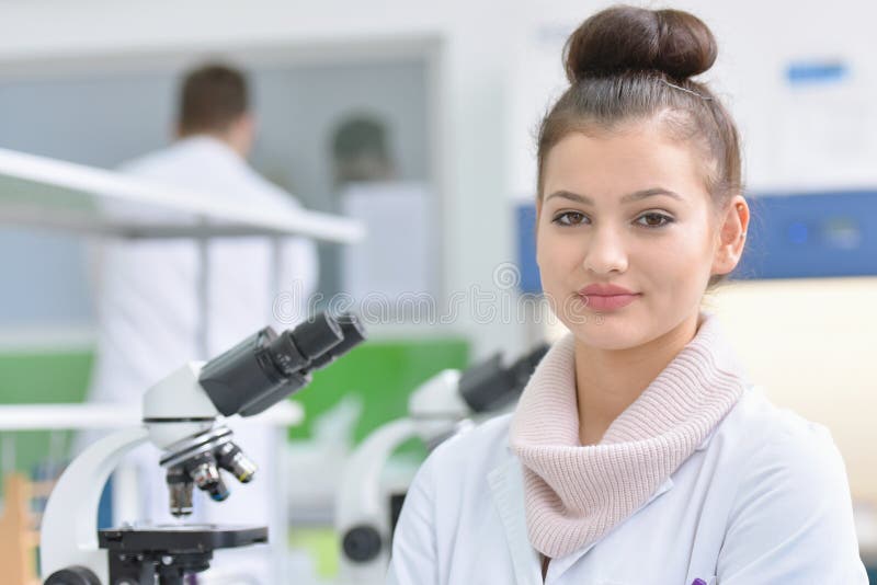 Group of Young Laboratory Scientists Working at Lab with Test Tubes and ...