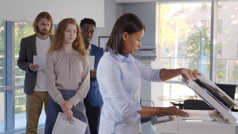 Group of Young Managers Standing in Queue for Copier at Office Stock ...