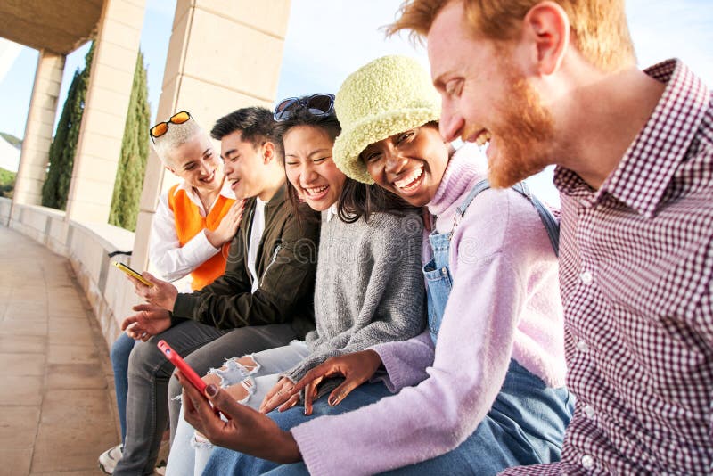 Group of Young Mixed Race People with Mobile Phones. Excited Students ...