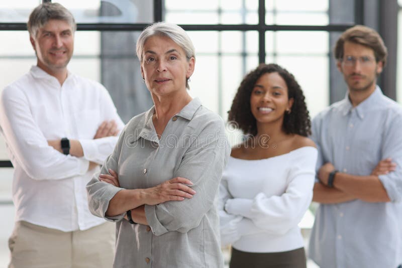 A Group of Young Modern People in Smart Casual Clothes, Studying while ...
