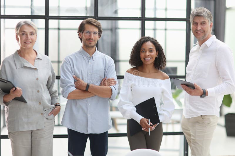 A Group of Young Modern People in Smart Casual Clothes, Studying while ...