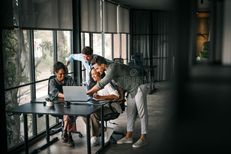 Group of Young Multi-ethnic Startup Business Team Collaborating on Project in Modern Office ...