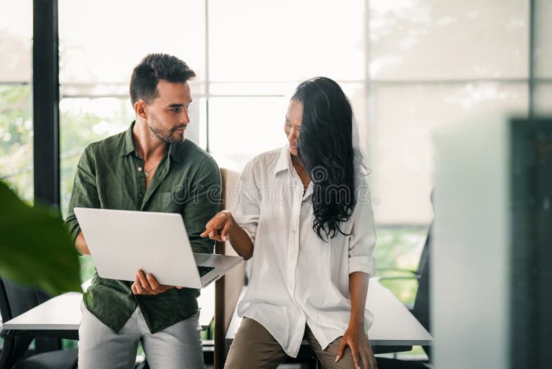 Group of Young Multi-ethnic Startup Business Team Collaborating on Project in Modern Office ...