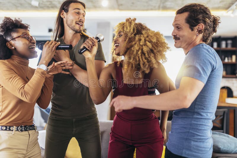Young Multicultural Friends Having Party Singing Song Using Microphone ...