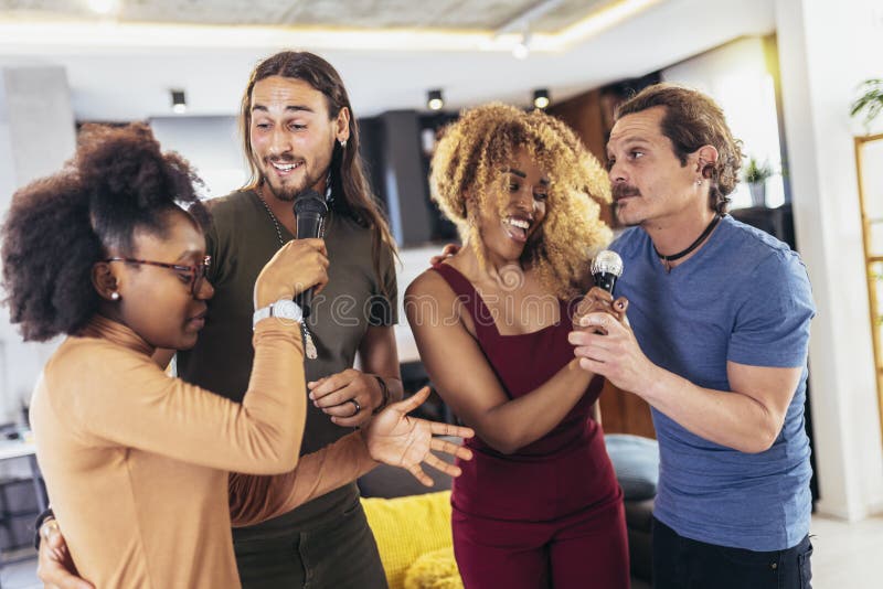 Young Multicultural Friends Having Party Singing Song Using Microphone ...