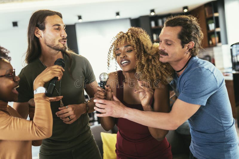 Young Multicultural Friends Having Party Singing Song Using Microphone ...