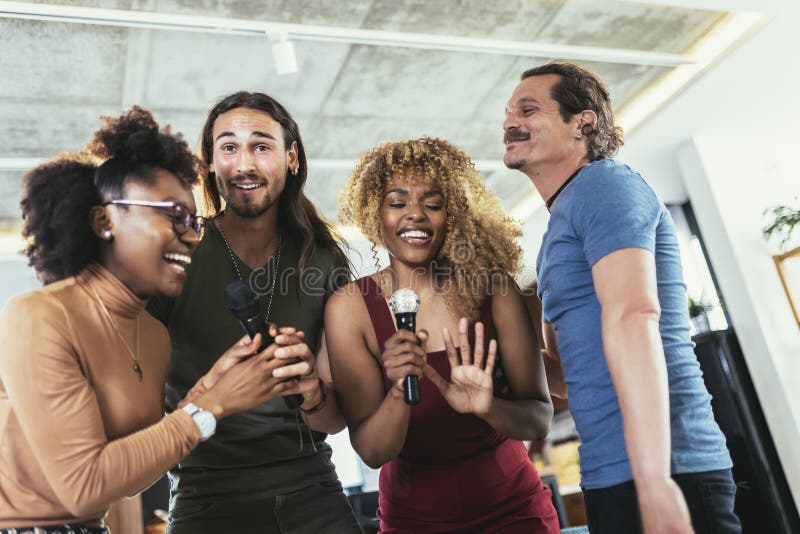 Young Multicultural Friends Having Party Singing Song Using Microphone ...