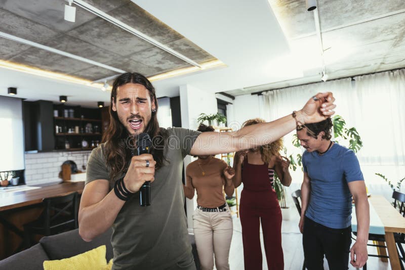 Young Multicultural Friends Having Party Singing Song Using Microphone ...