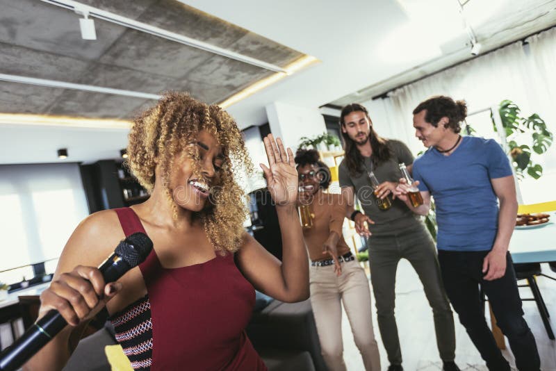 Young Multicultural Friends Having Party Singing Song Using Microphone ...