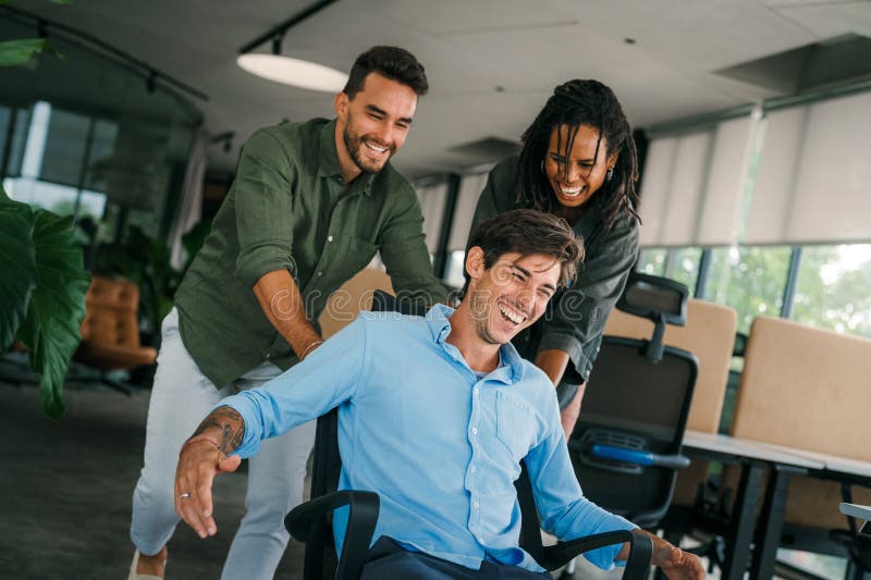 Group of Young Multiracial Diverse Office Workers is Caught in a Moment ...