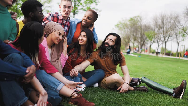 Group Of Young Multiracial Friends Having Fun Together In Park Stock