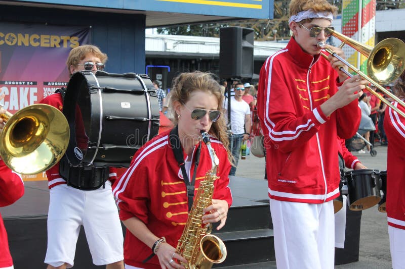 Group of Young Musicians in Red and White Uniforms Playing Their ...