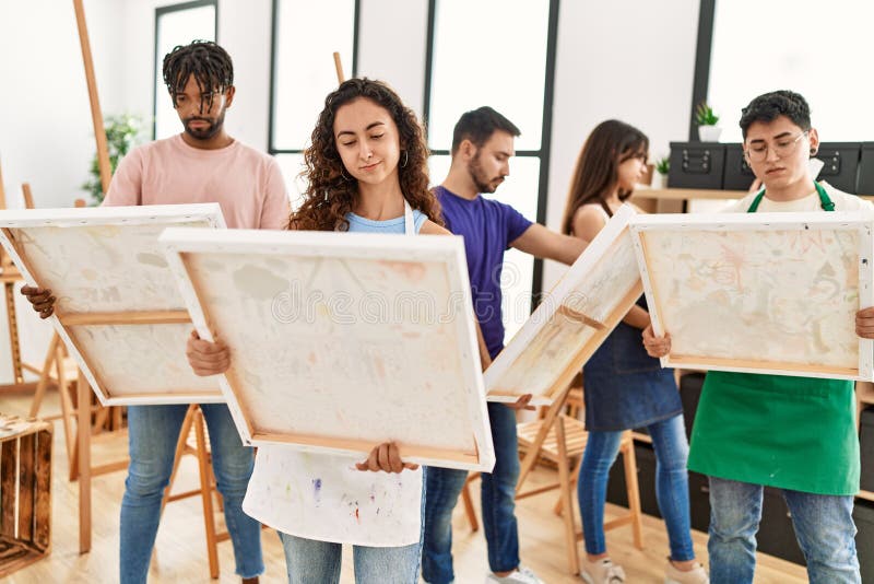 Group of Young Paint Students Smiling Happy Holding Canvas Standing at ...