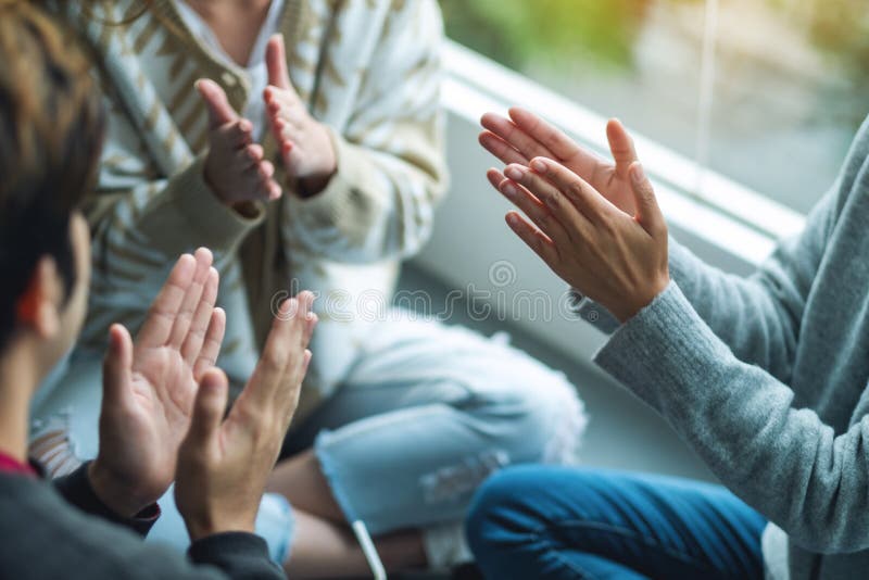 A Group of People Clapping Hands while Sitting Together Stock Photo ...