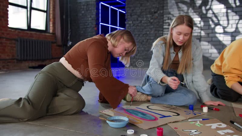 A Group of Young People Draw Posters and Protest Against Environmental ...