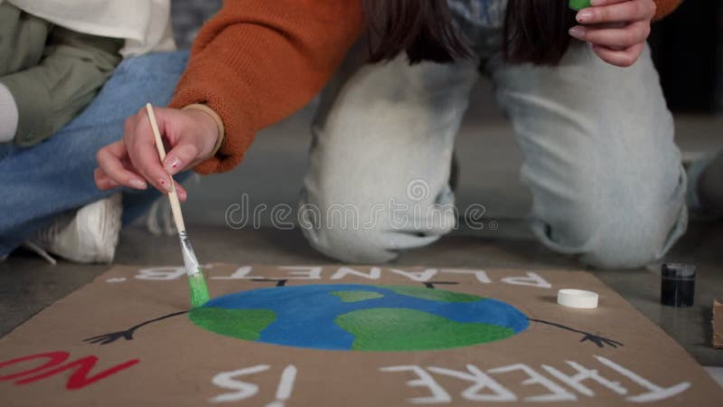 A Group of Young People Draw Posters and Protest Against Environmental ...