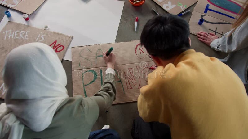 A Group of Young People Draw Posters and Protest Against Environmental ...